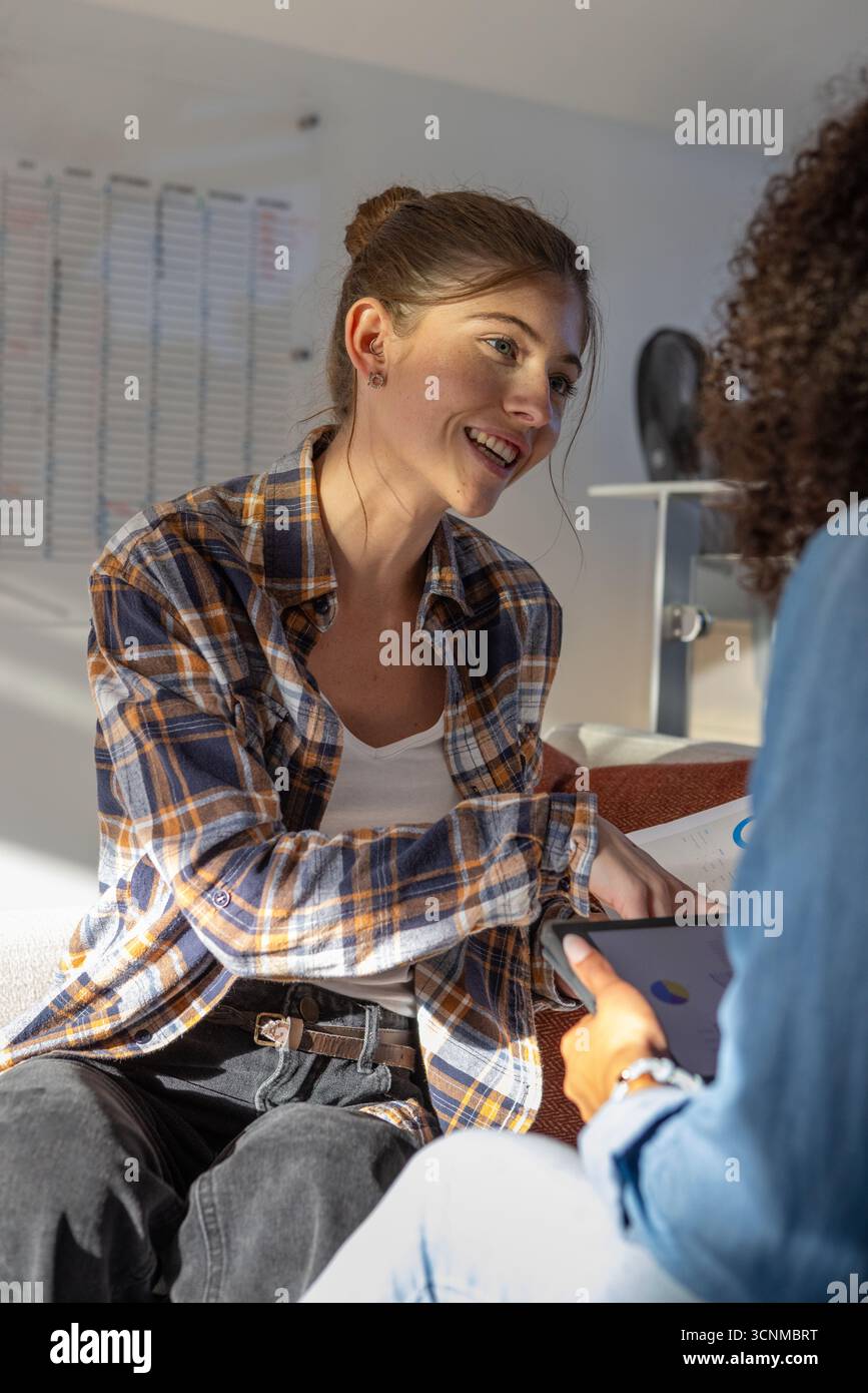 Reviewing printed chart diverse coworkers hi-res stock photography and ...