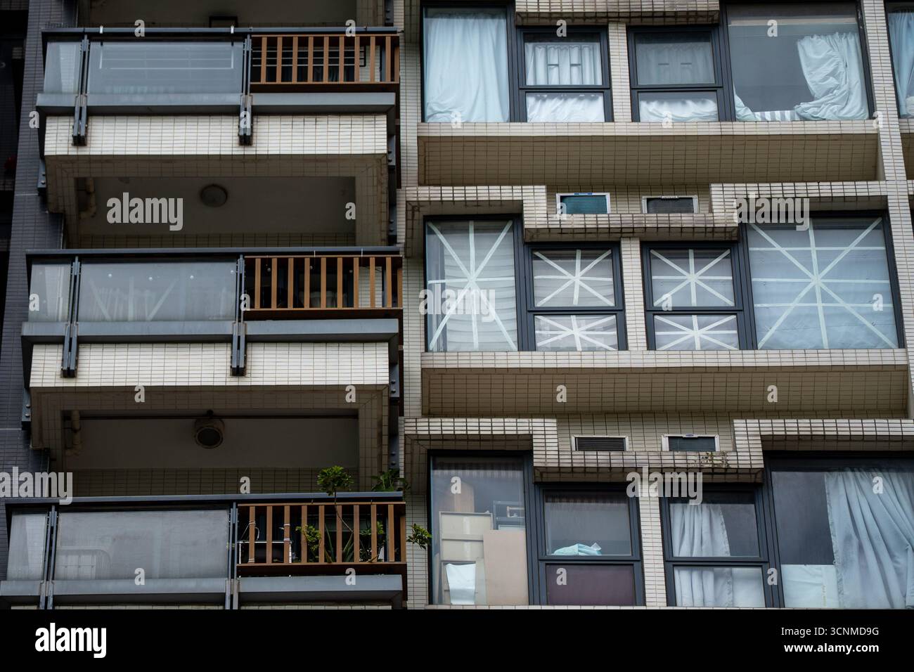 A residential apartment with tapes on its windows to prepare for ...