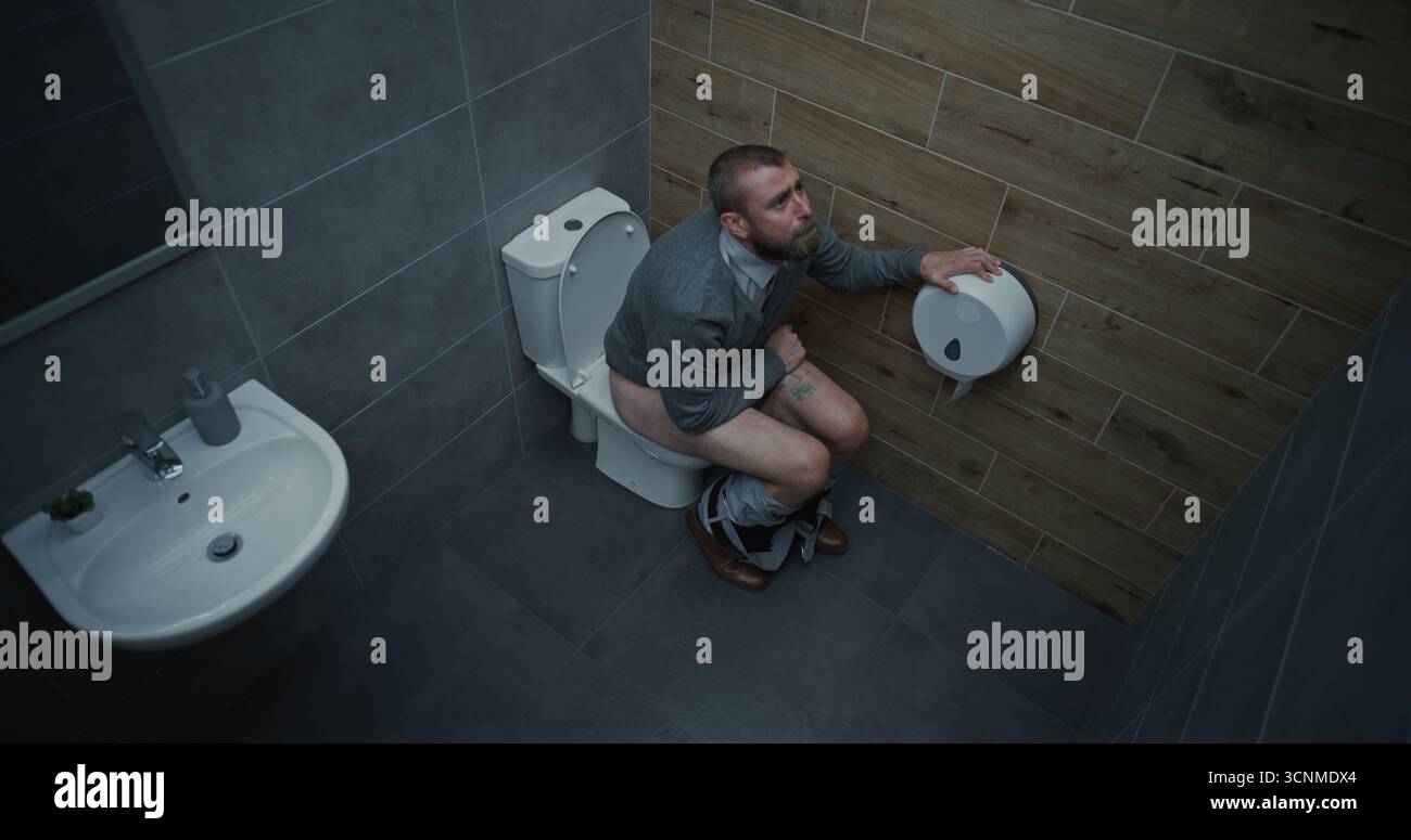 Businessman Taking Off His Pants, Sitting on the Toilet, Suffering from ...