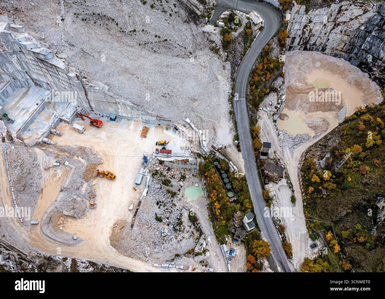 Aerial view of stark white marble quarries carved into the mountainside ...