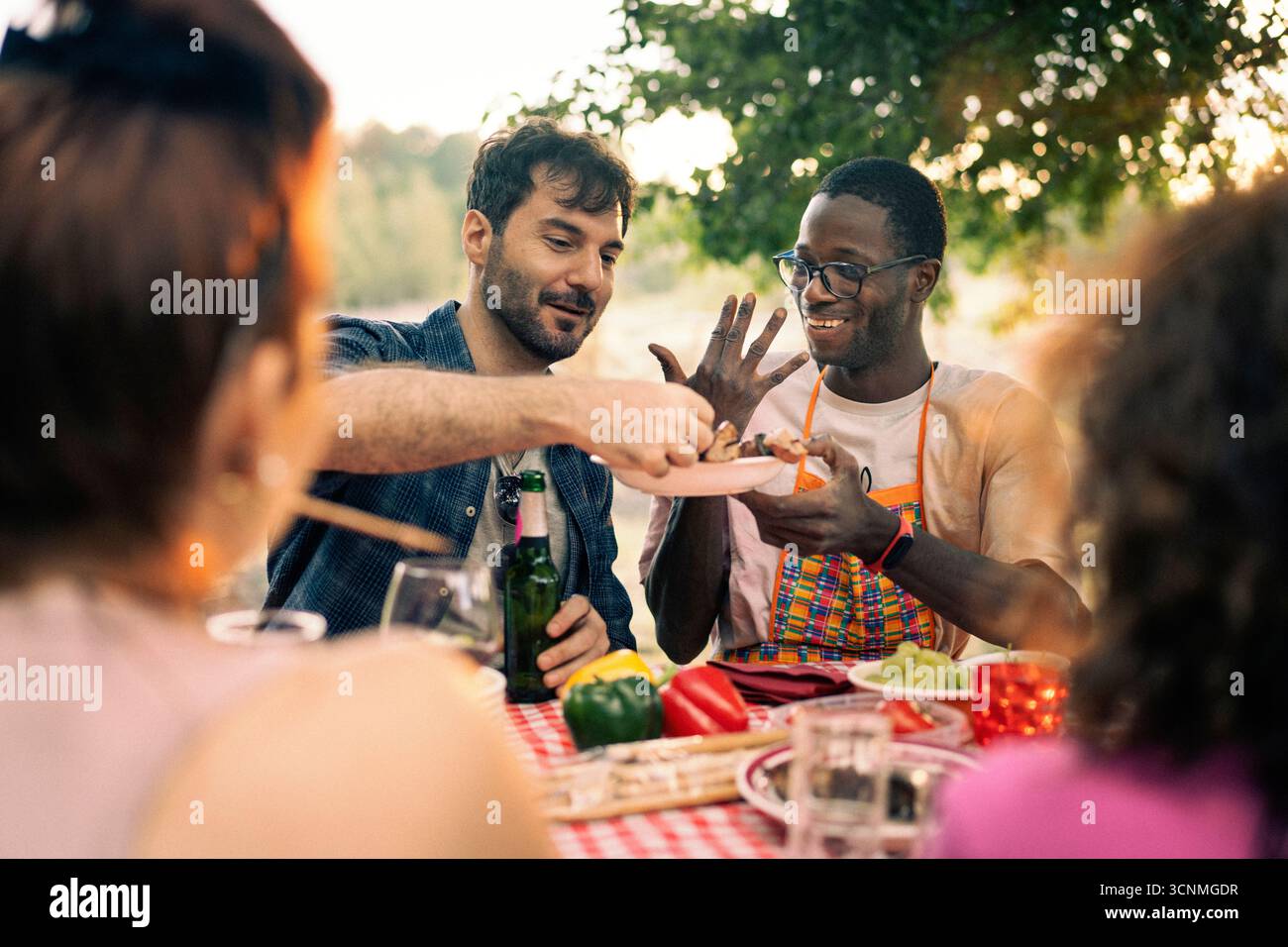 Two happy male friends share a candid moment, talking and laughing ...