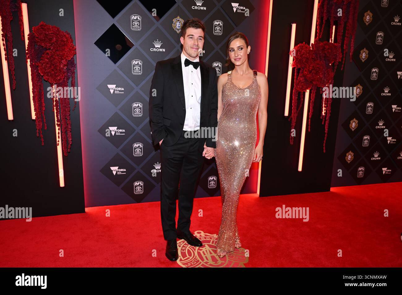 Zach Merrett of Essendon (left) and Alexandra Merrett pose for a photo ...