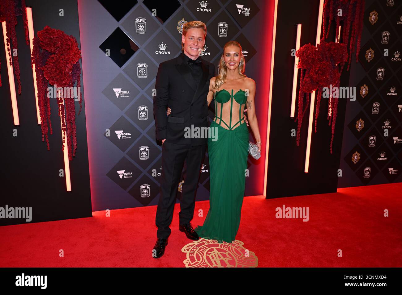 Isaac Heeney of the Swans (left) and Steffanie Waters pose for a photo ...