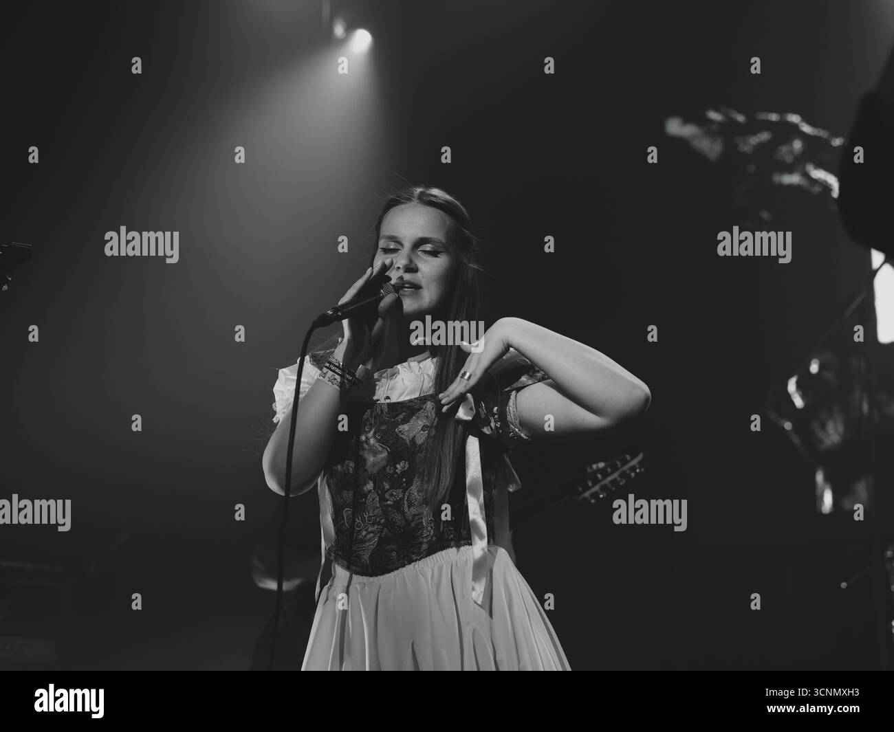 Singer performs on stage wearing traditional attire during concert ...