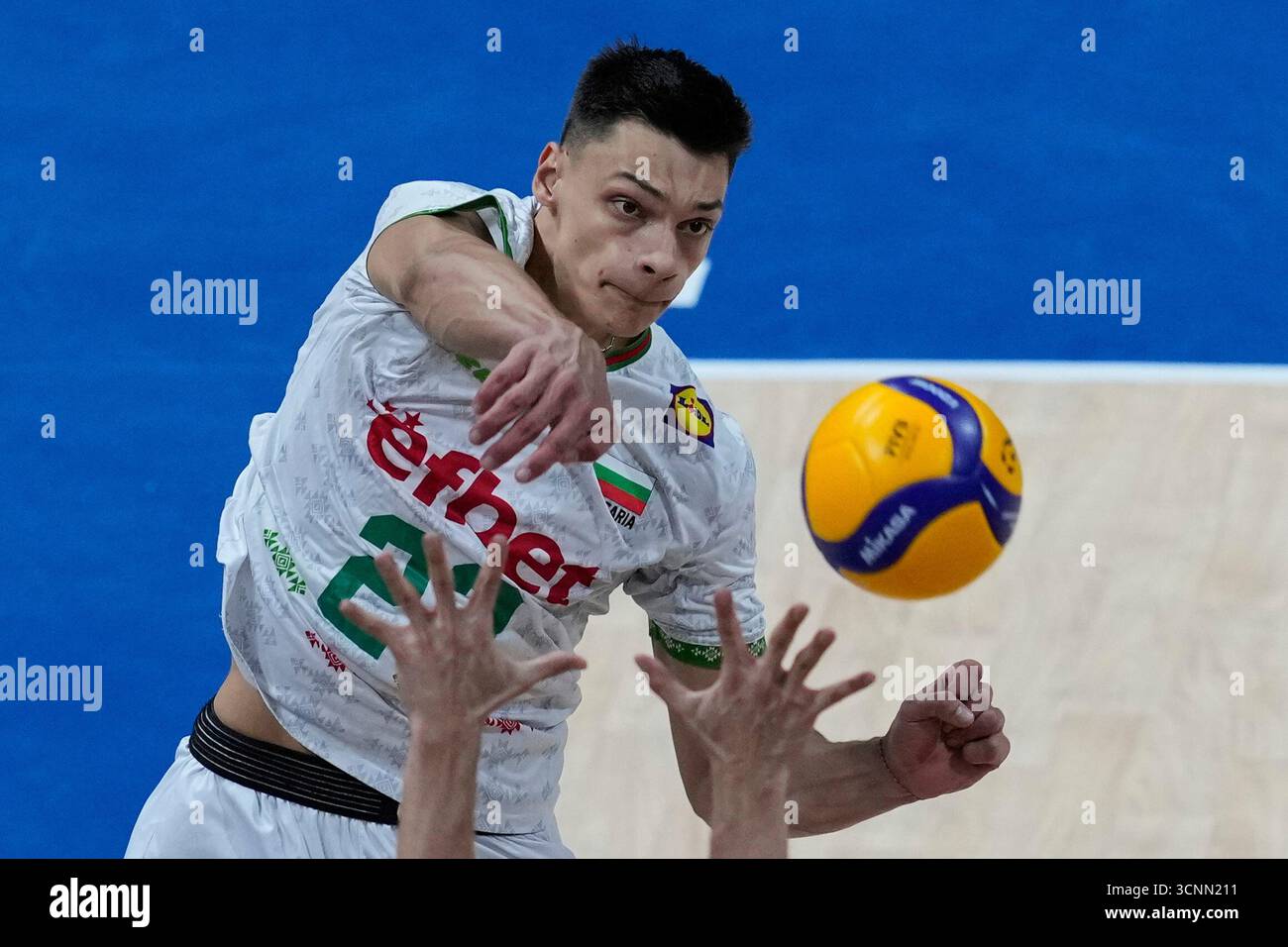 Aleksandar Nikolov, left, of Bulgaria spikes the ball against Portugal ...