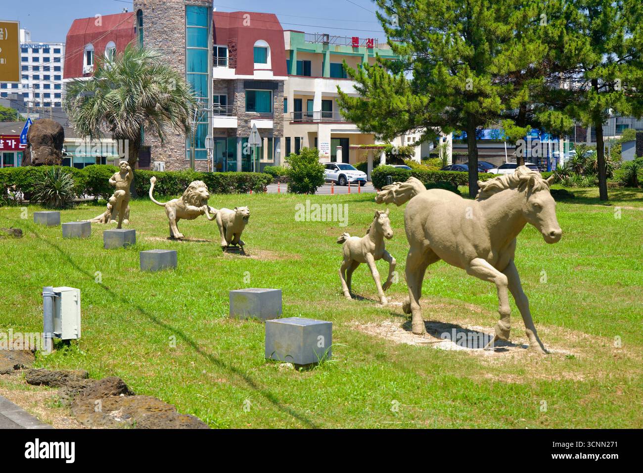 A row of animal sculptures, including horses and big cats, lines a ...