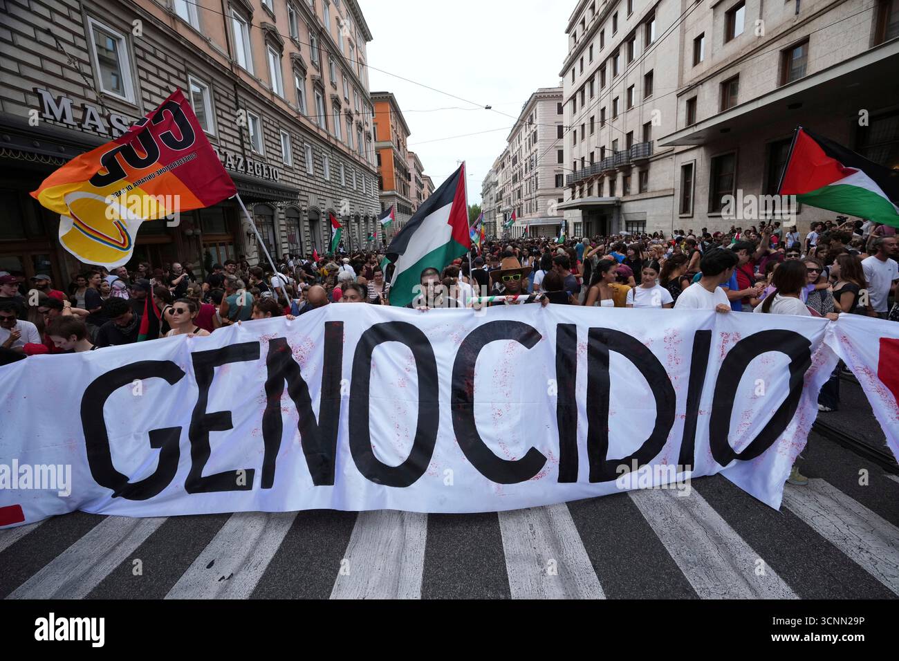 People hold a banner reading "genocide" as they participate at a ...