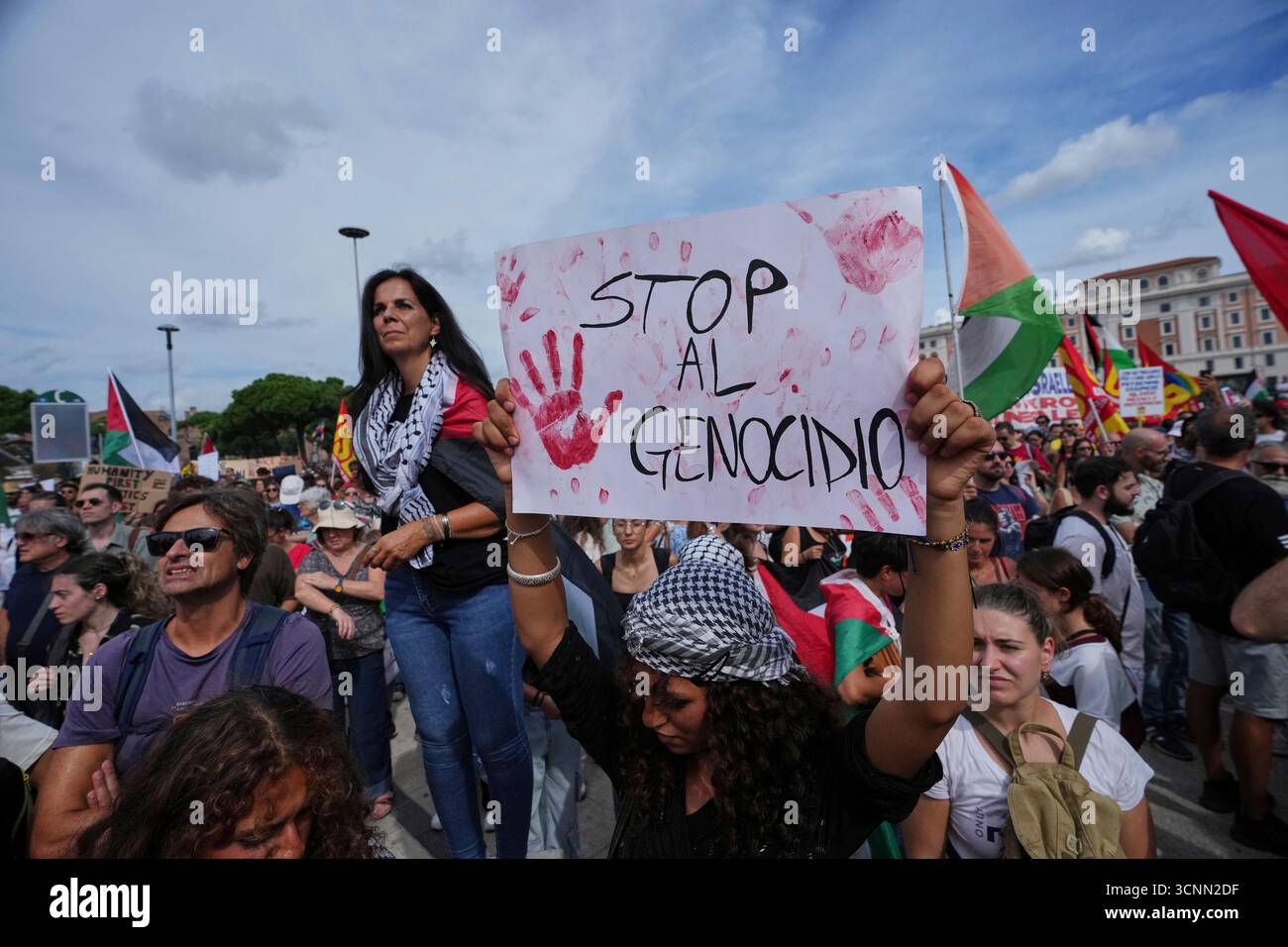 People hold banners reading "stop genocide"as they participate at a ...