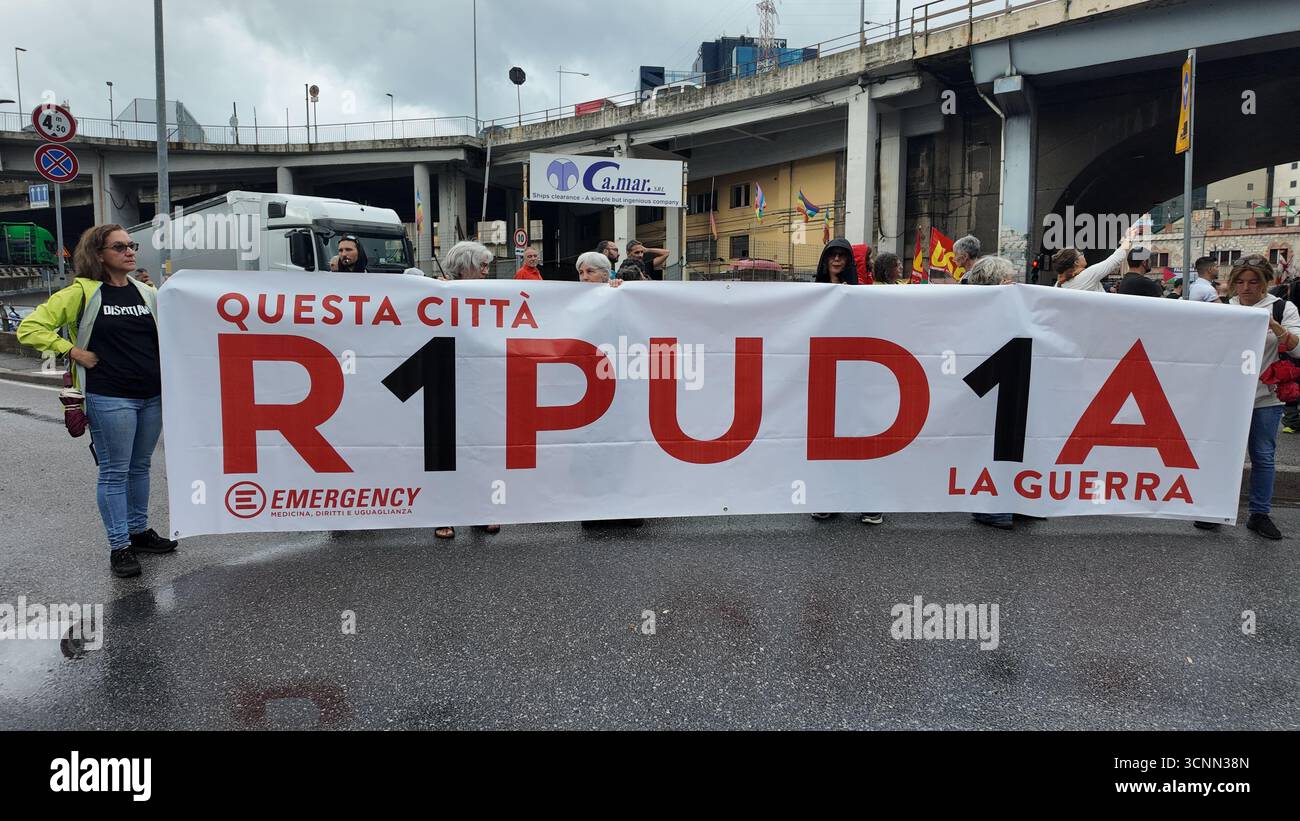 Genoa, Italy. 22 September 2025. Protesters display a banner reading ...