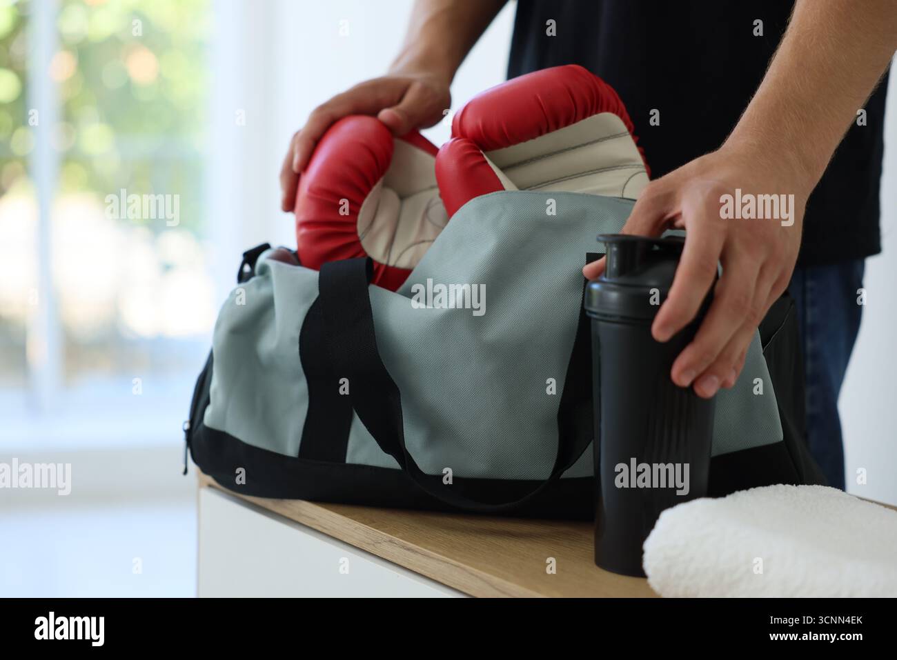 Man packing sports bag hi-res stock photography and images - Alamy
