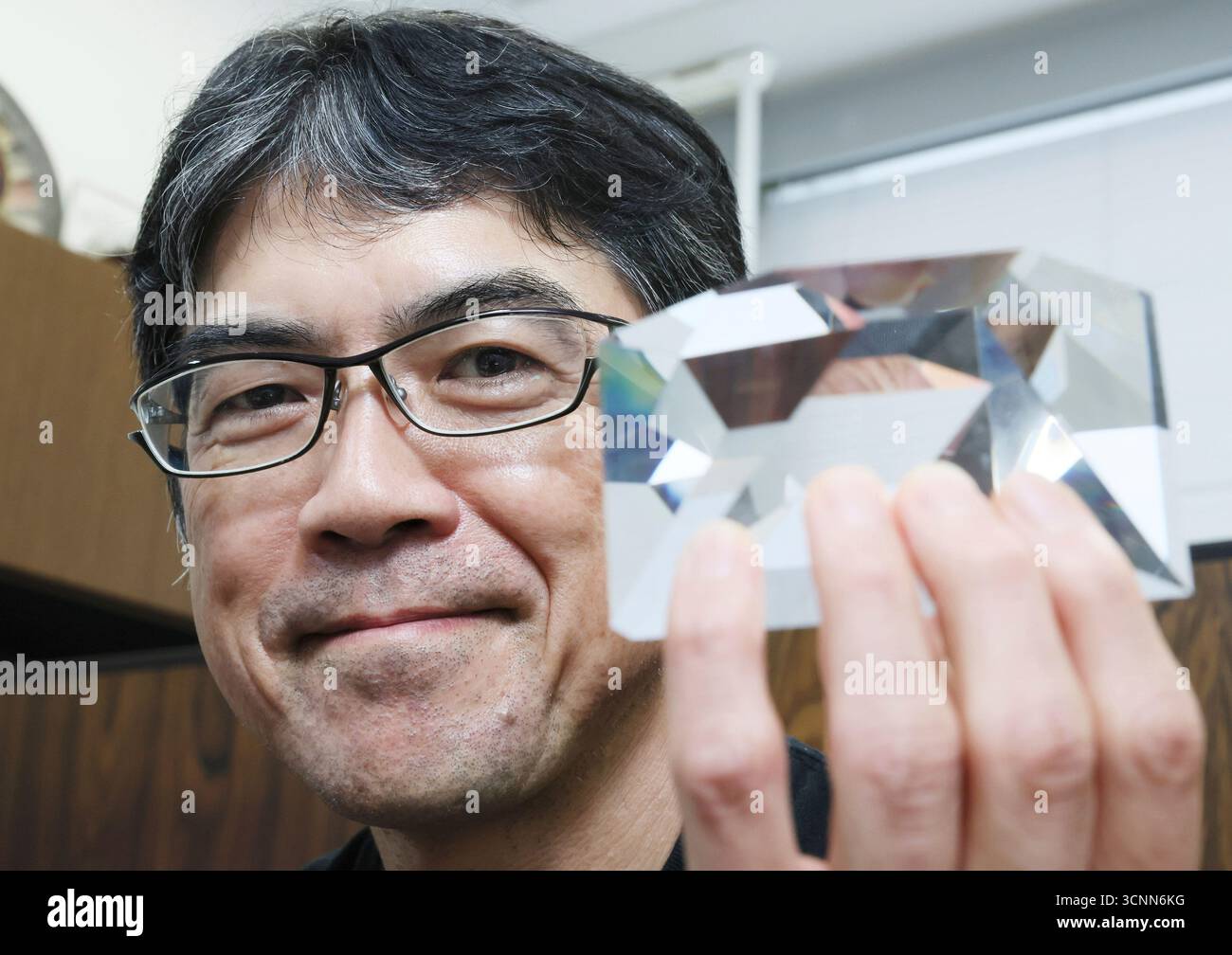 Professor Yusuke Mori of Osaka University poses for a photo during an interview in Suita City ...