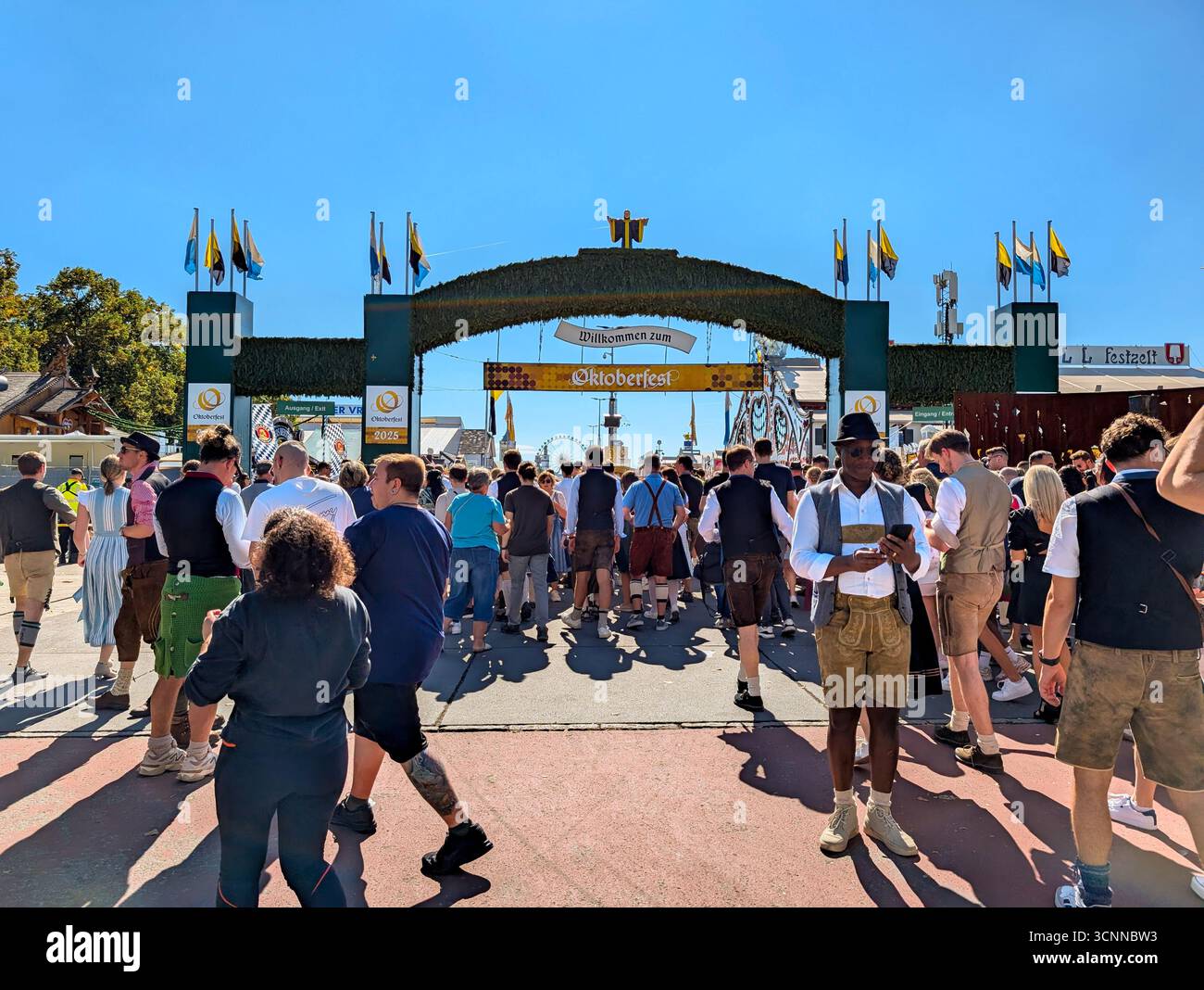 Munich, Germany. 21st Sep, 2025. Visitors enter the festival grounds ...
