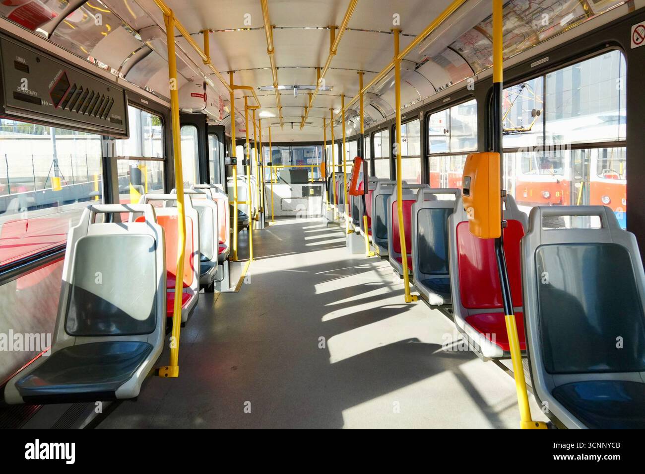 Interior of a bus with empty seats and yellow trolleys Stock Photo - Alamy