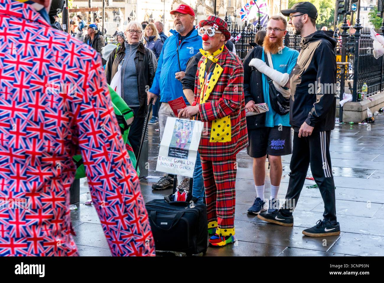 A Man Dressed As A Clown Holds A Sign At The Unite The Kingdom Rally In ...