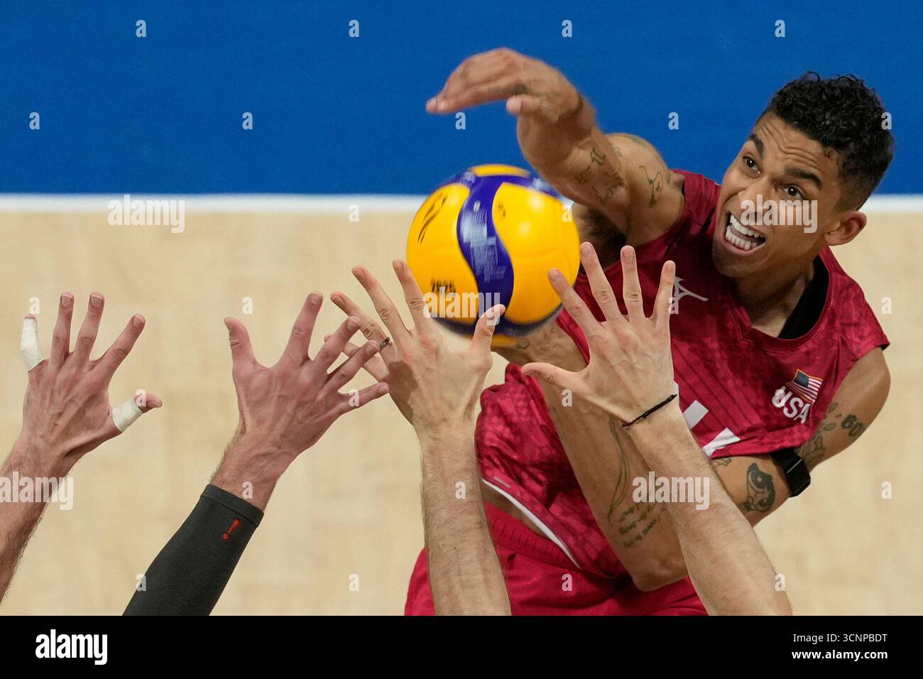 Merrick McHenry of the United States spikes the ball against Slovenia ...