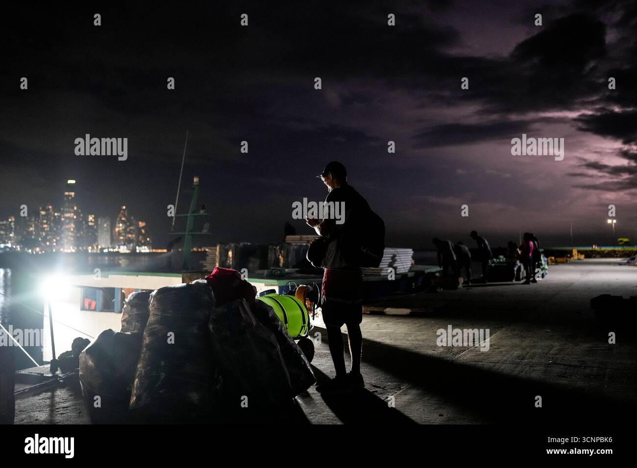 Venezuelan Abraham Castro stands on a dock in Panama City as he waits ...