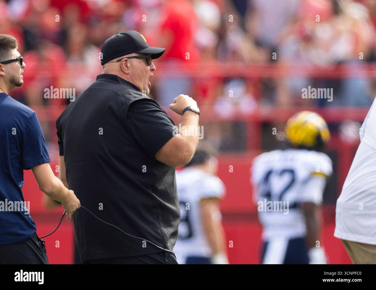 Michigan acting head coach Biff Poggi reacts after his team made a ...