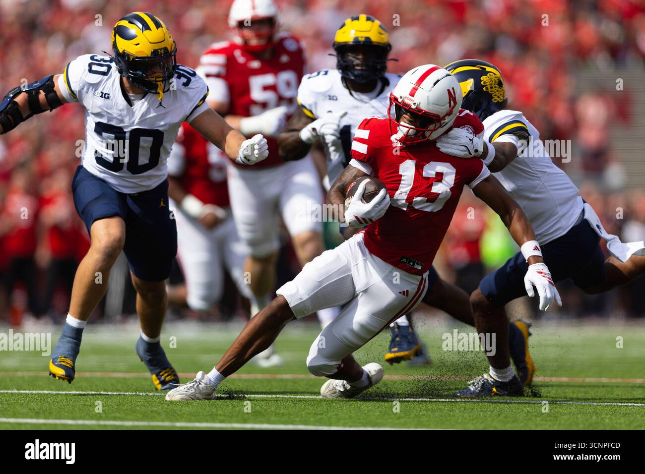 Michigan defensive back Brandyn Hillman, right, tackles Nebraska wide ...