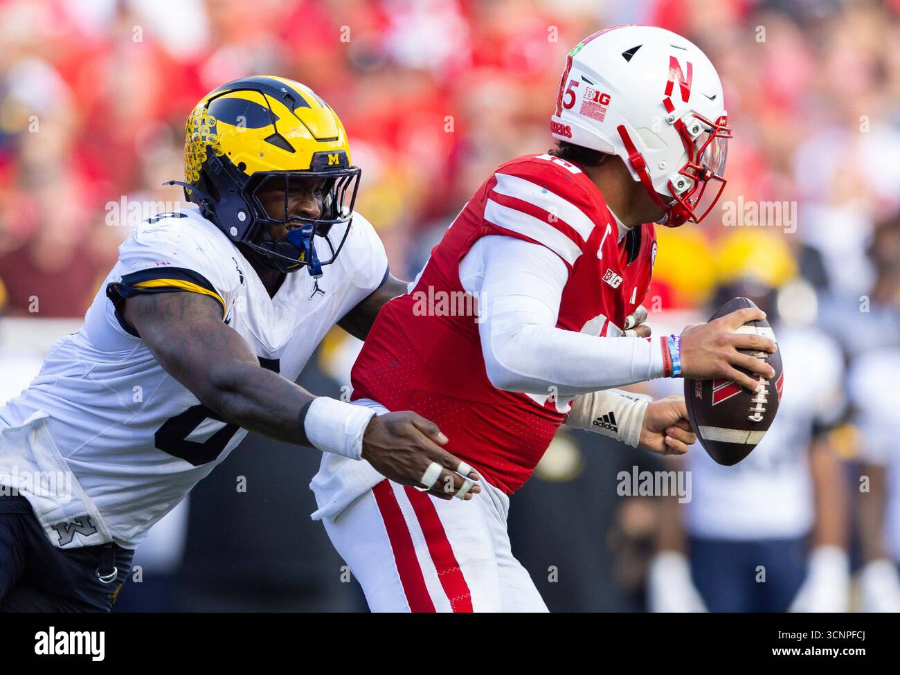 Michigan edge Derrick Moore, left, tackles Nebraska quarterback Dylan ...