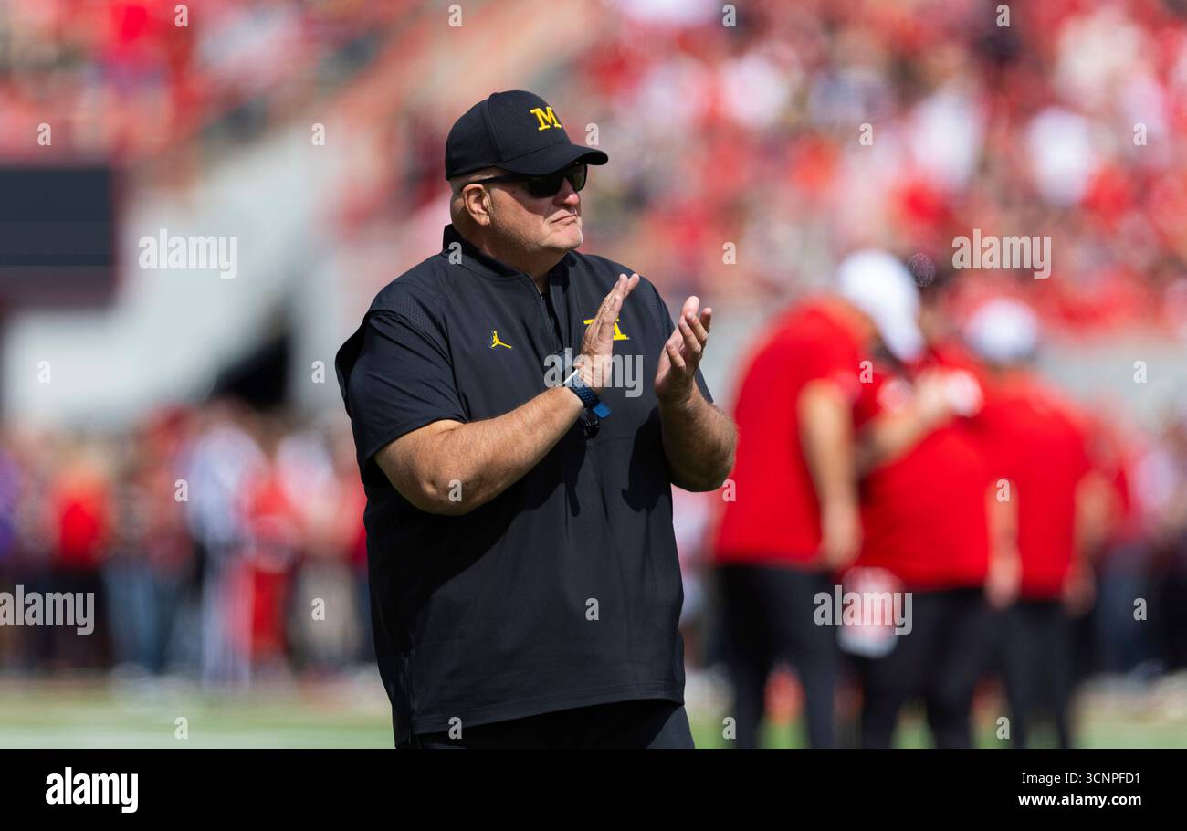 Michigan acting head coach Biff Poggi watches his team warm up before ...