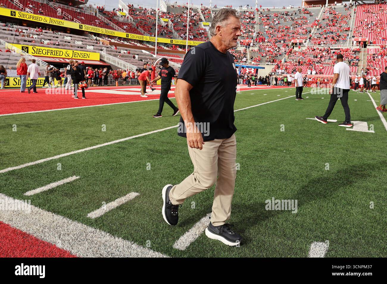 Utah head coach Kyle Whittingham walks onto the field during an NCAA ...