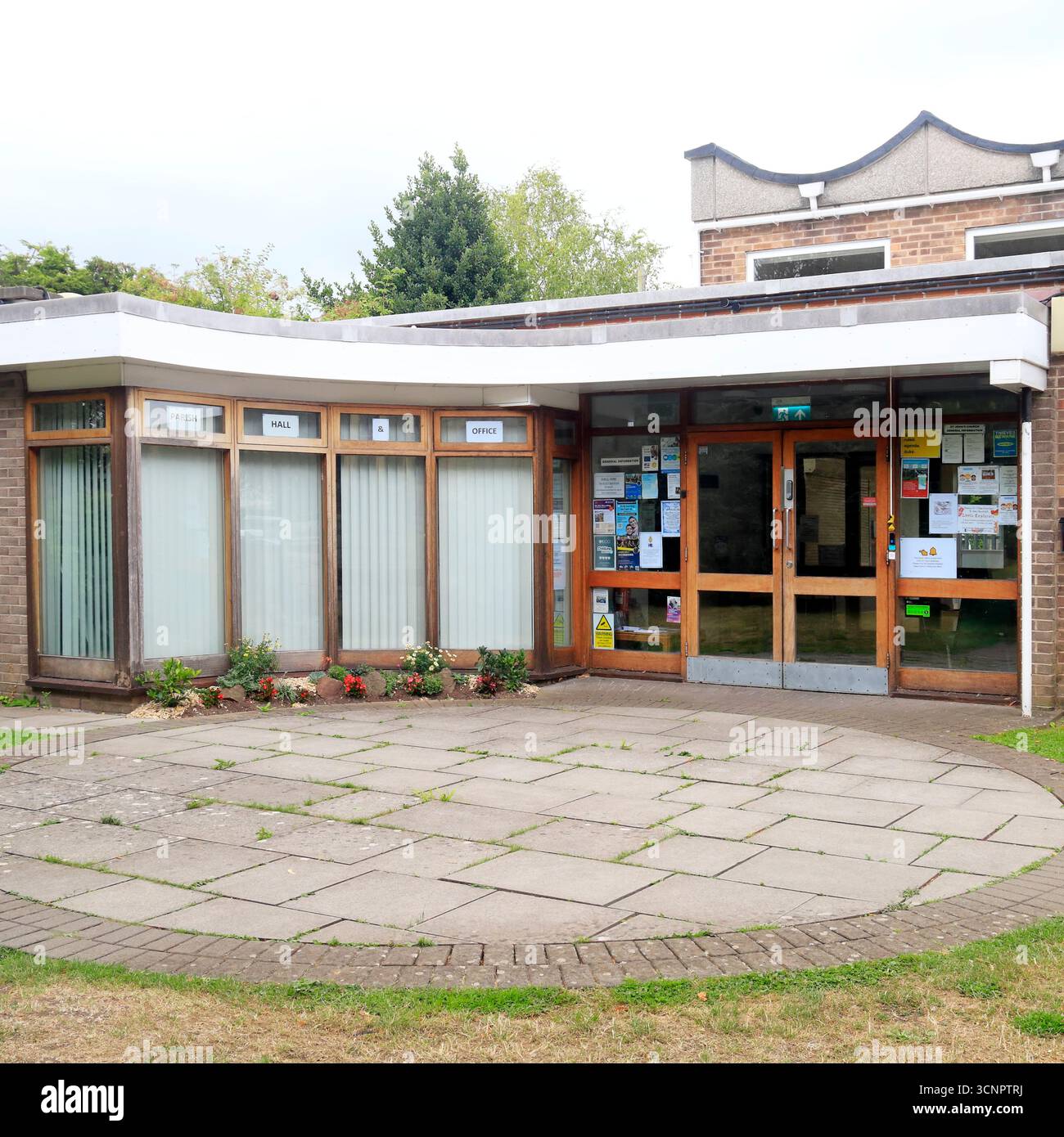 Modern brick Community Centre behind St John the Baptist church ...