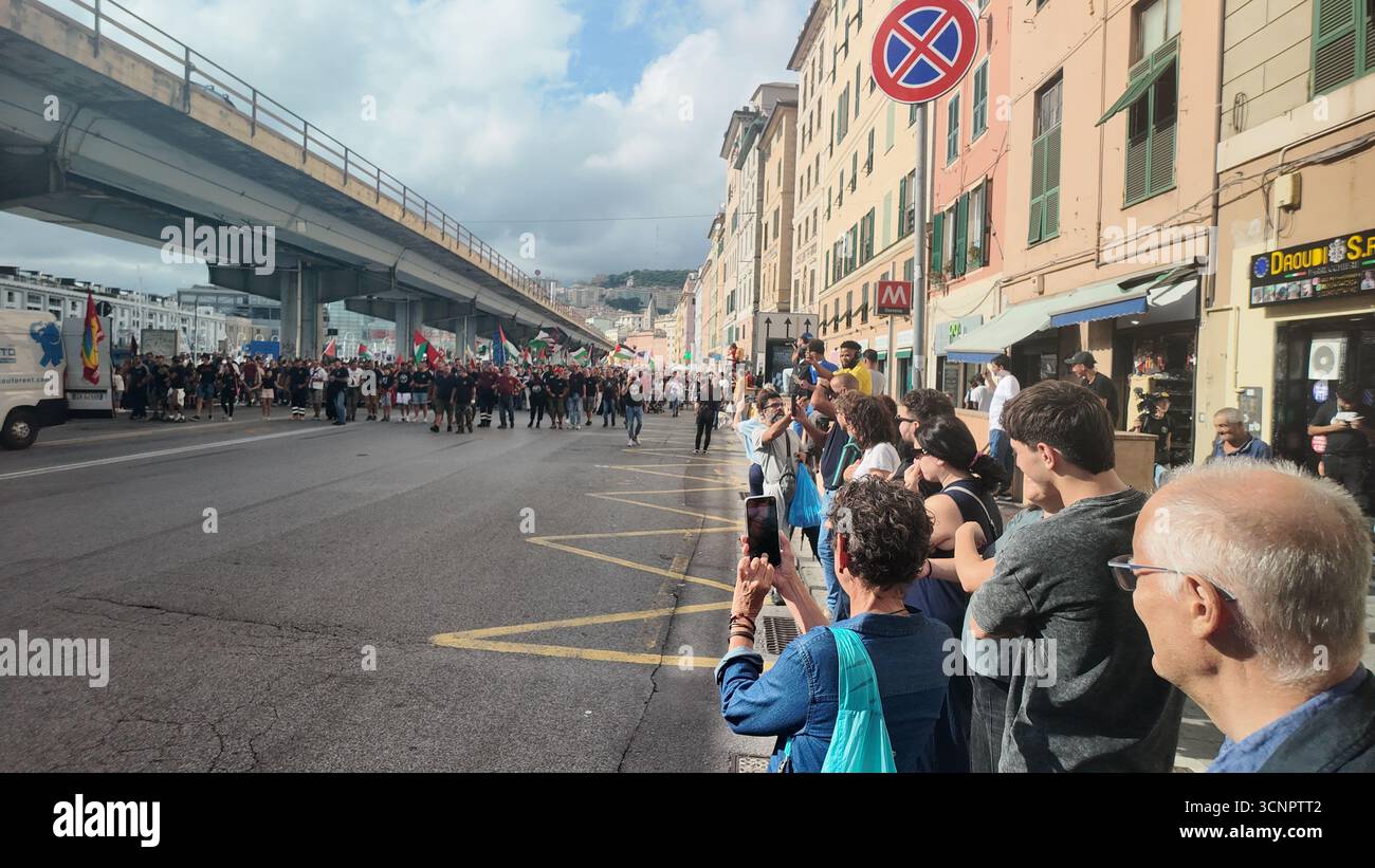 Genoa, Italy. 22 September 2025. People film as demonstrators march ...