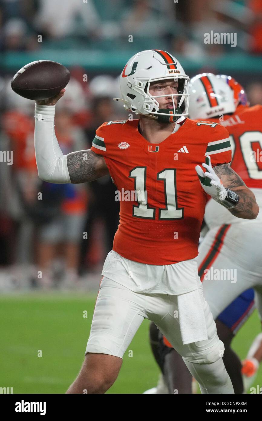 Miami quarterback Carson Beck (11) aims a pass during an NCAA college ...