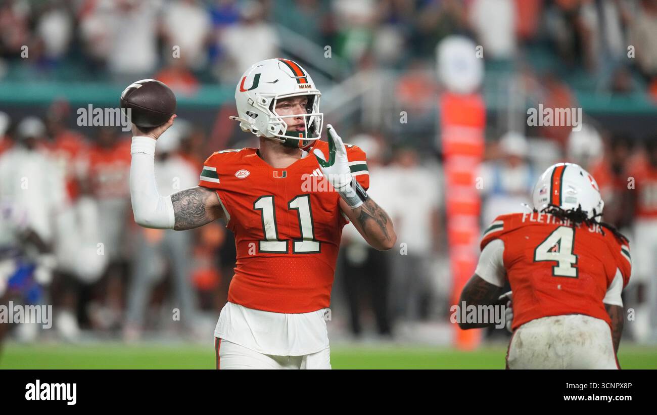 Miami quarterback Carson Beck (11) aims a pass during an NCAA college ...