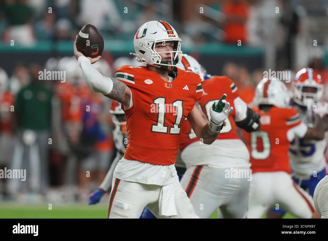 Miami quarterback Carson Beck (11) aims a pass during an NCAA college ...