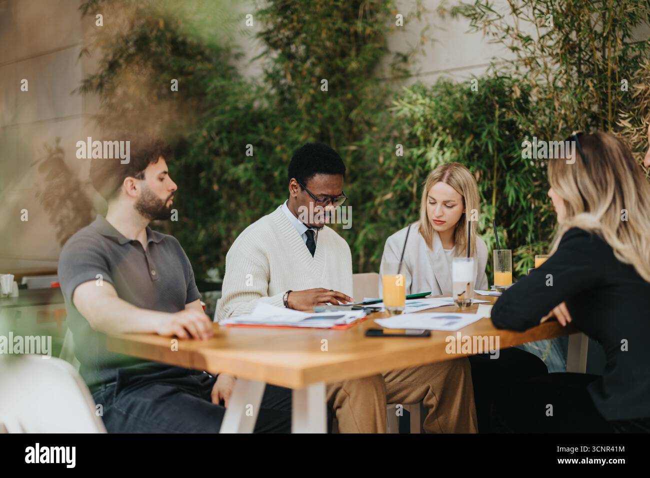 Group of professionals collaborating in an outdoor setting Stock Photo ...