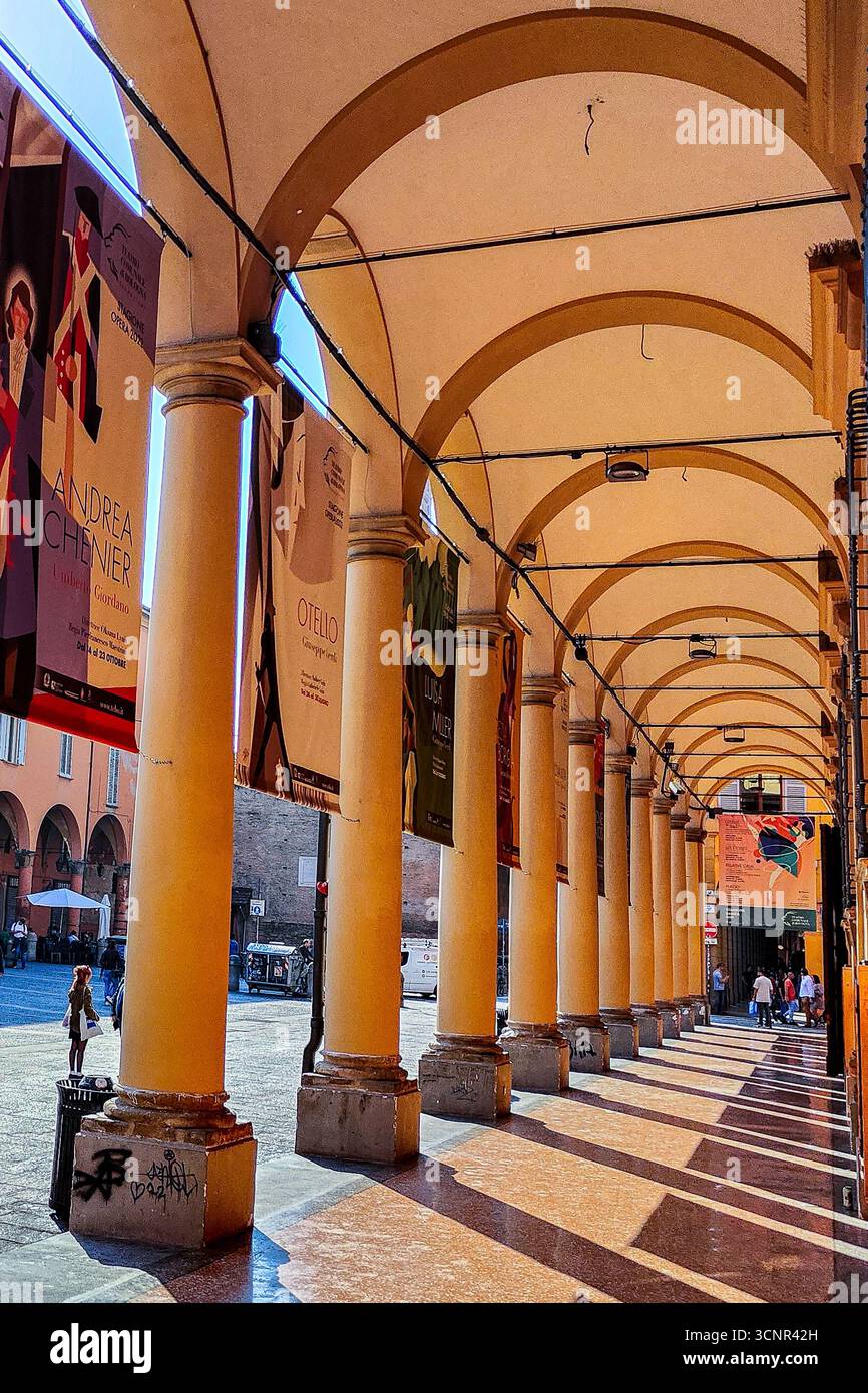 Portico walkway with columns and posters in Bologna, Italy Stock Photo ...