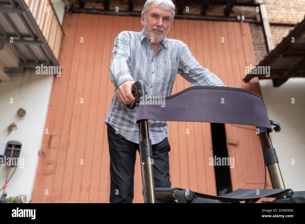 Germany - September 21, 2025: An elderly man stands in front of a ...