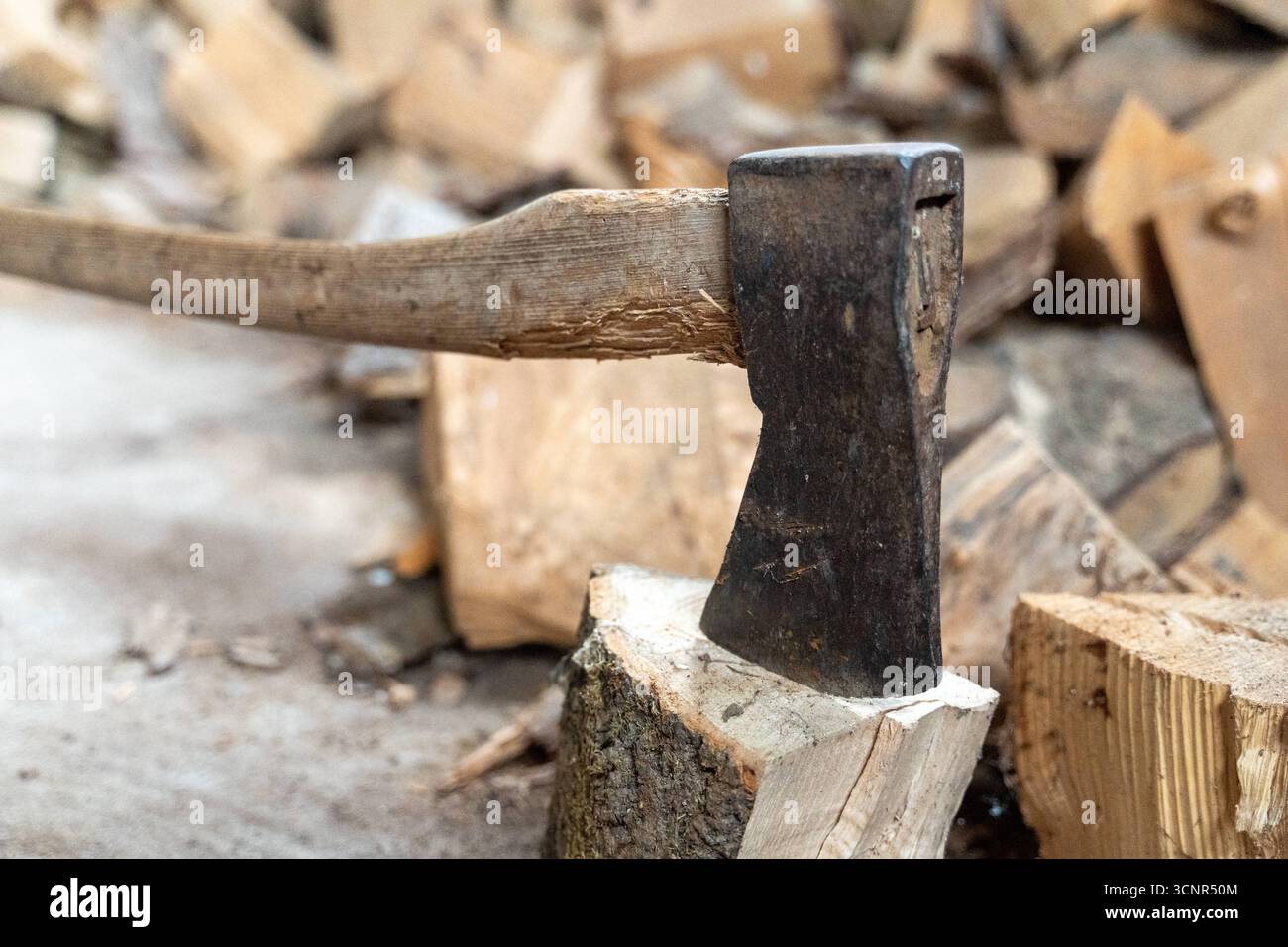 Germany - September 21, 2025: An axe is stuck in a log. The image ...