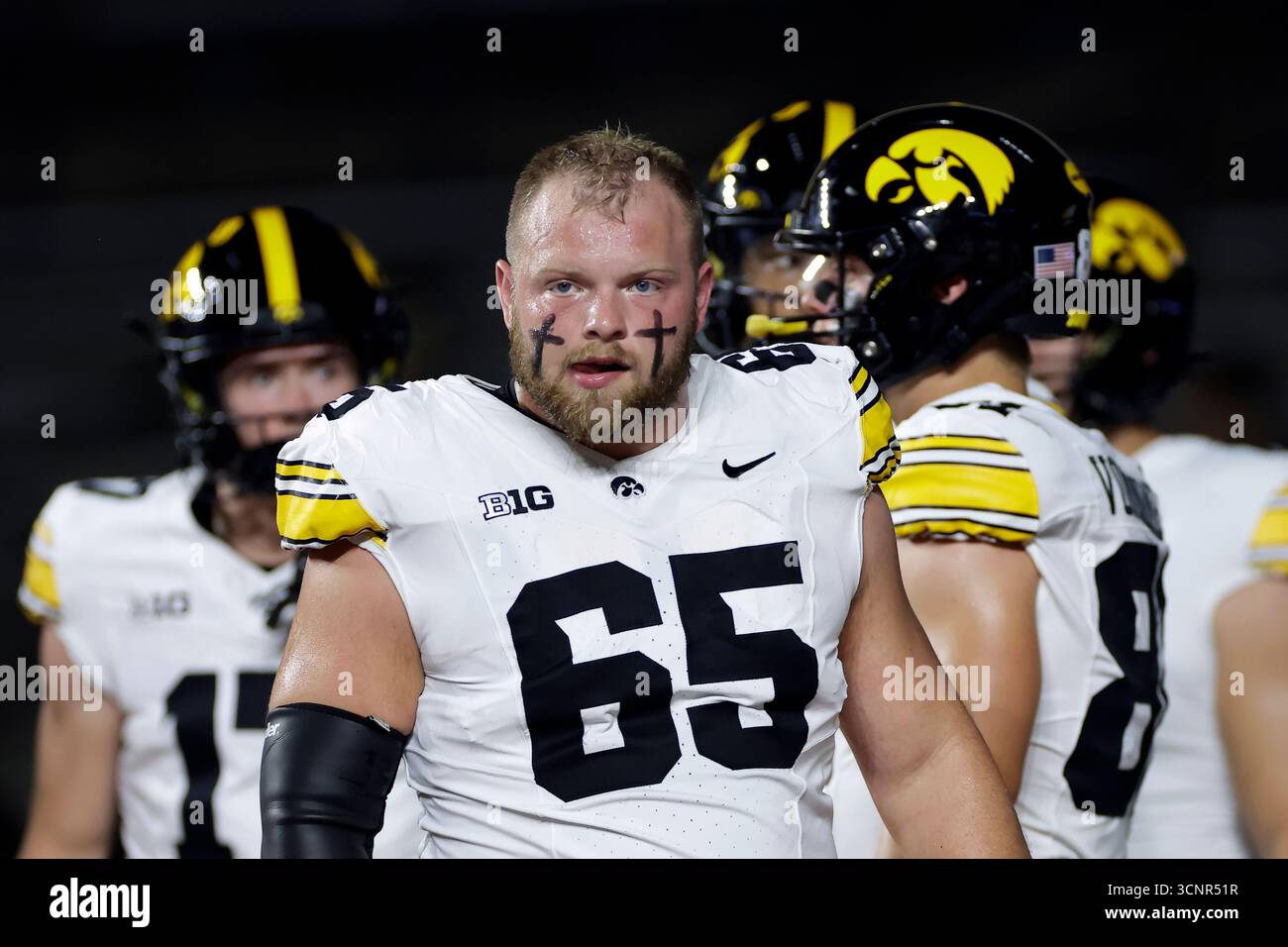 Iowa offensive lineman Logan Jones (65) warms up before an NCAA ...