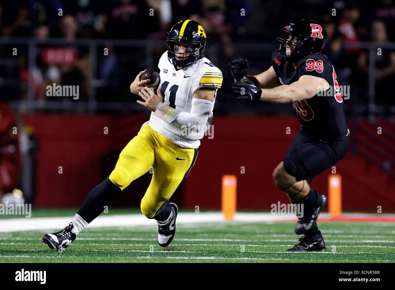 Iowa quarterback Mark Gronowski (11) runs with the ball during an NCAA ...