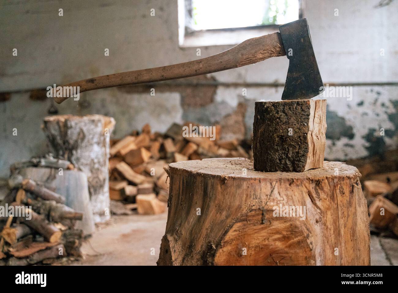 Germany - September 21, 2025: An axe is stuck in a log. The image ...