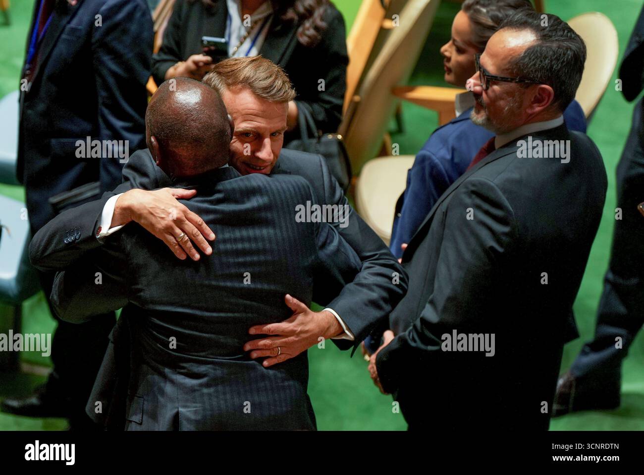 French President Emmanuel Macron, center, greets delegates upon ...