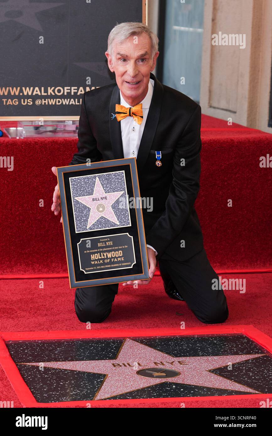 Bill Nye poses with his new star during a ceremony on the Hollywood ...