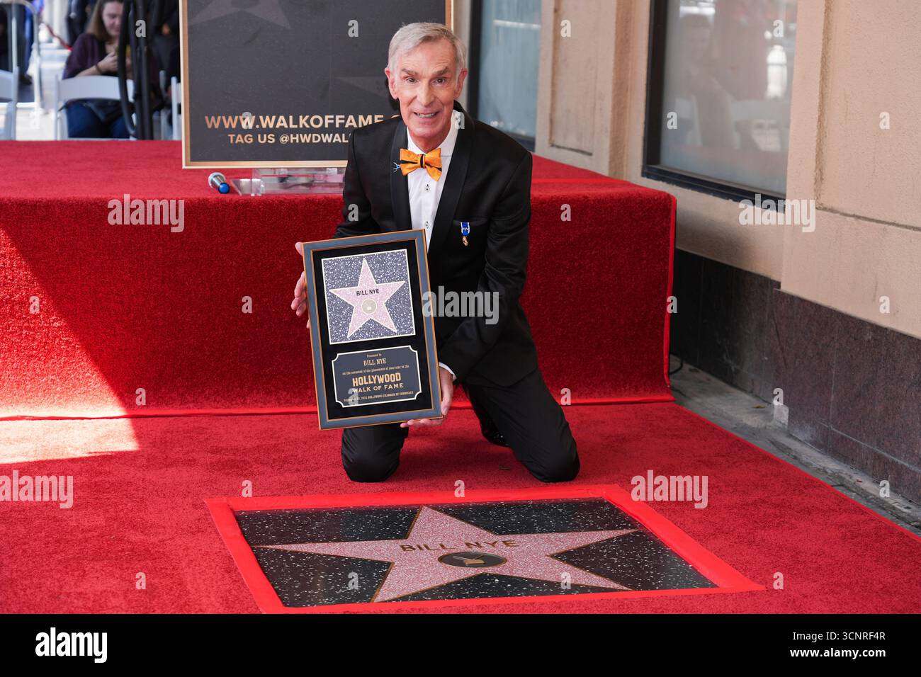 Bill Nye poses with his new star during a ceremony on the Hollywood ...