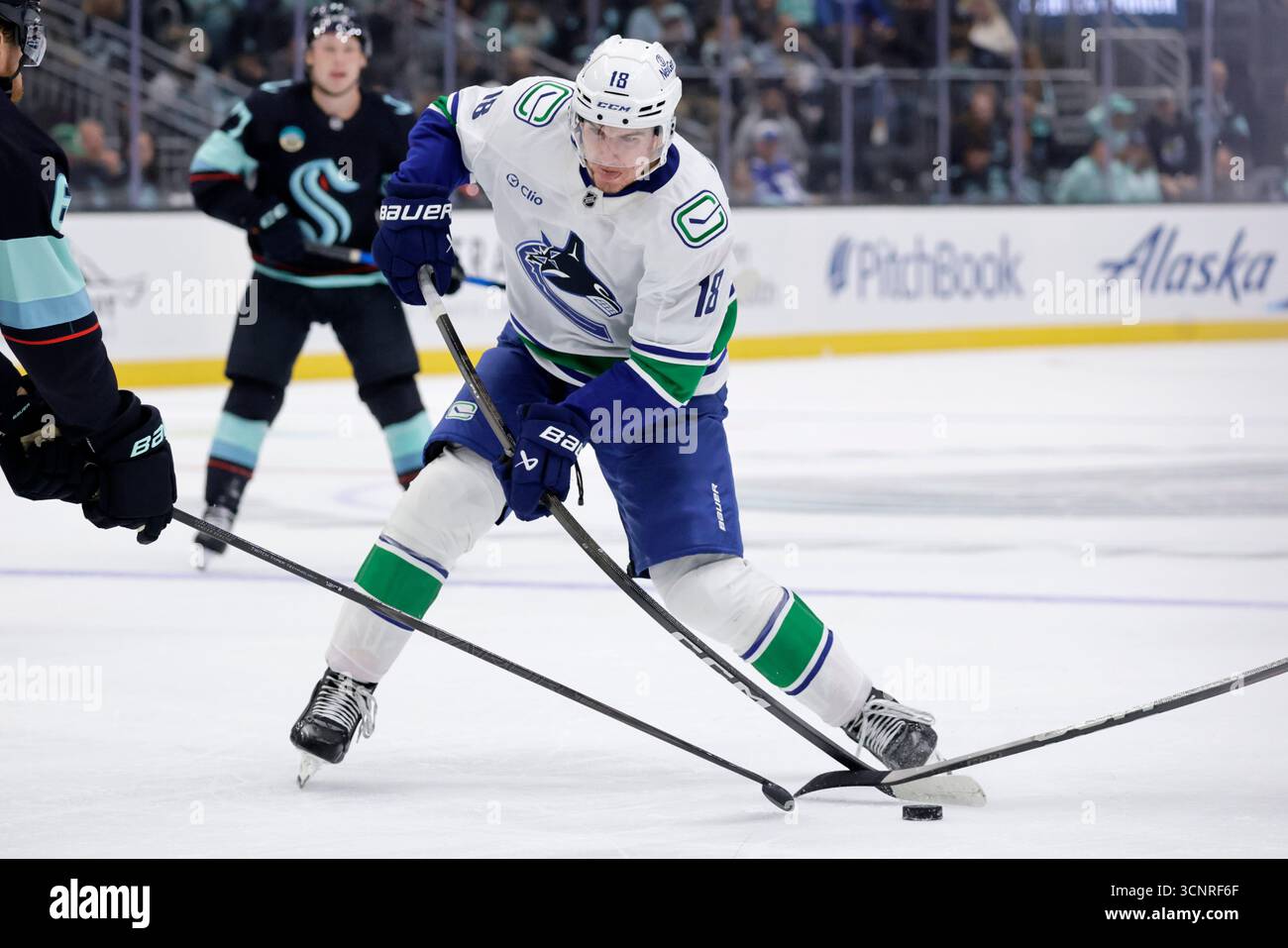 Vancouver Canucks left wing Drew O'Connor (18) shoots under pressure ...