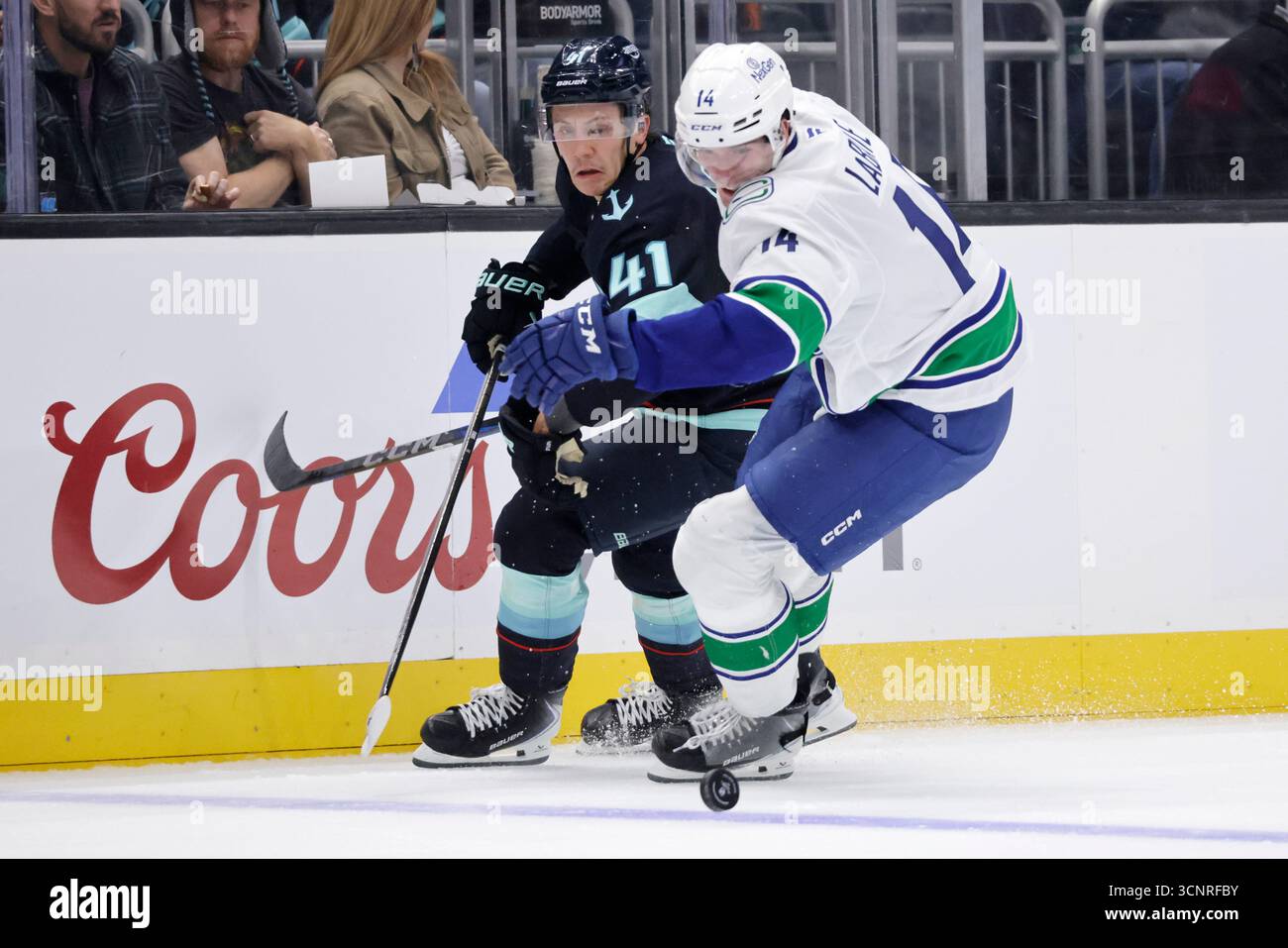 Seattle Kraken defenseman Ryker Evans (41) and Vancouver Canucks center ...
