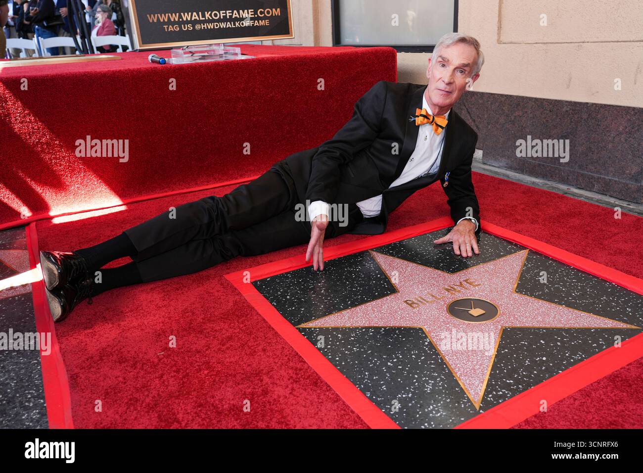 Bill Nye poses with his new star during a ceremony on the Hollywood ...