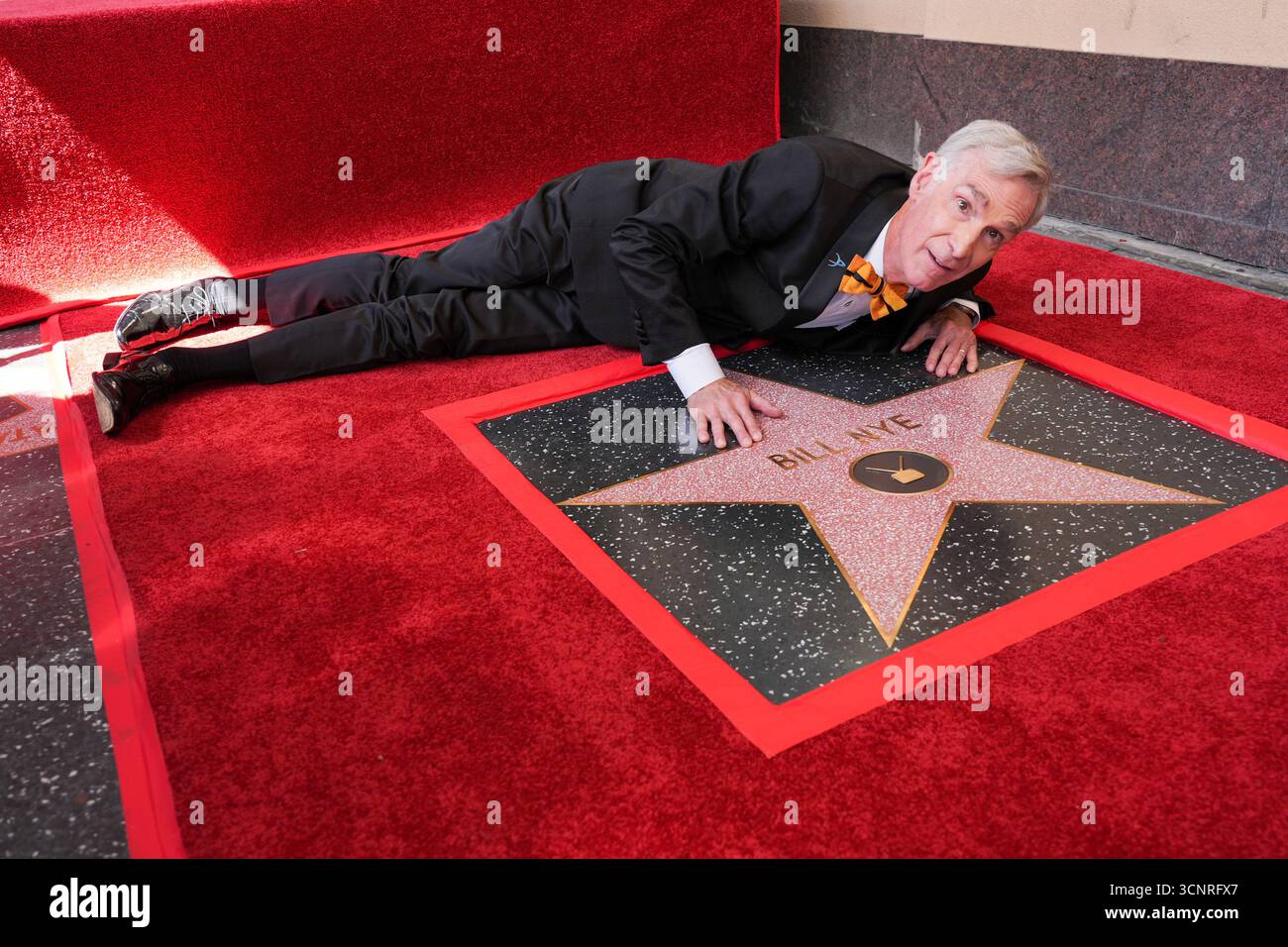 Bill Nye poses with his new star during a ceremony on the Hollywood ...