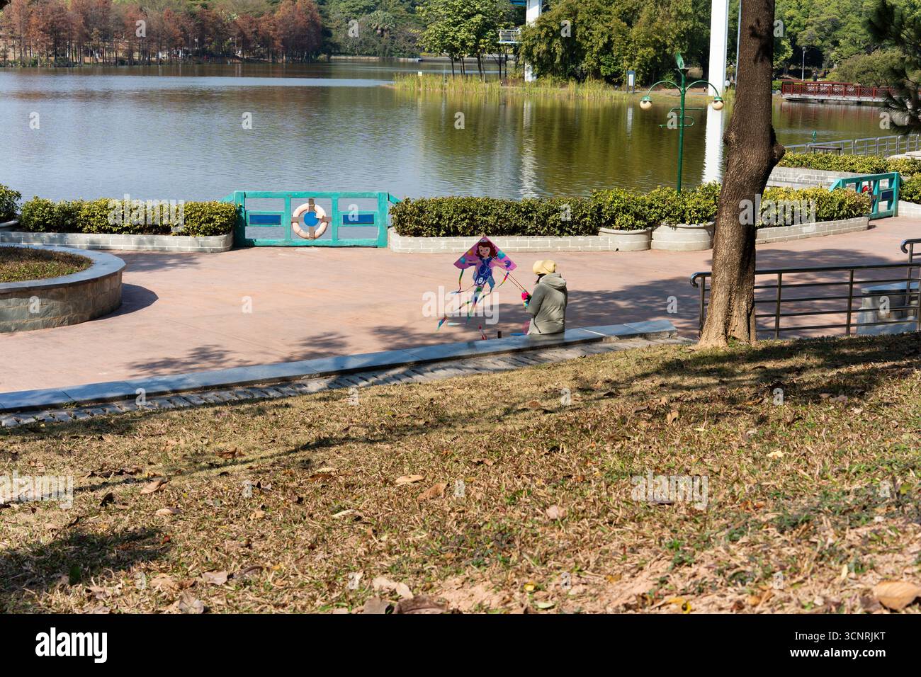 Child running in a park near a lake - West Lake in Huizhou, Guangdong ...