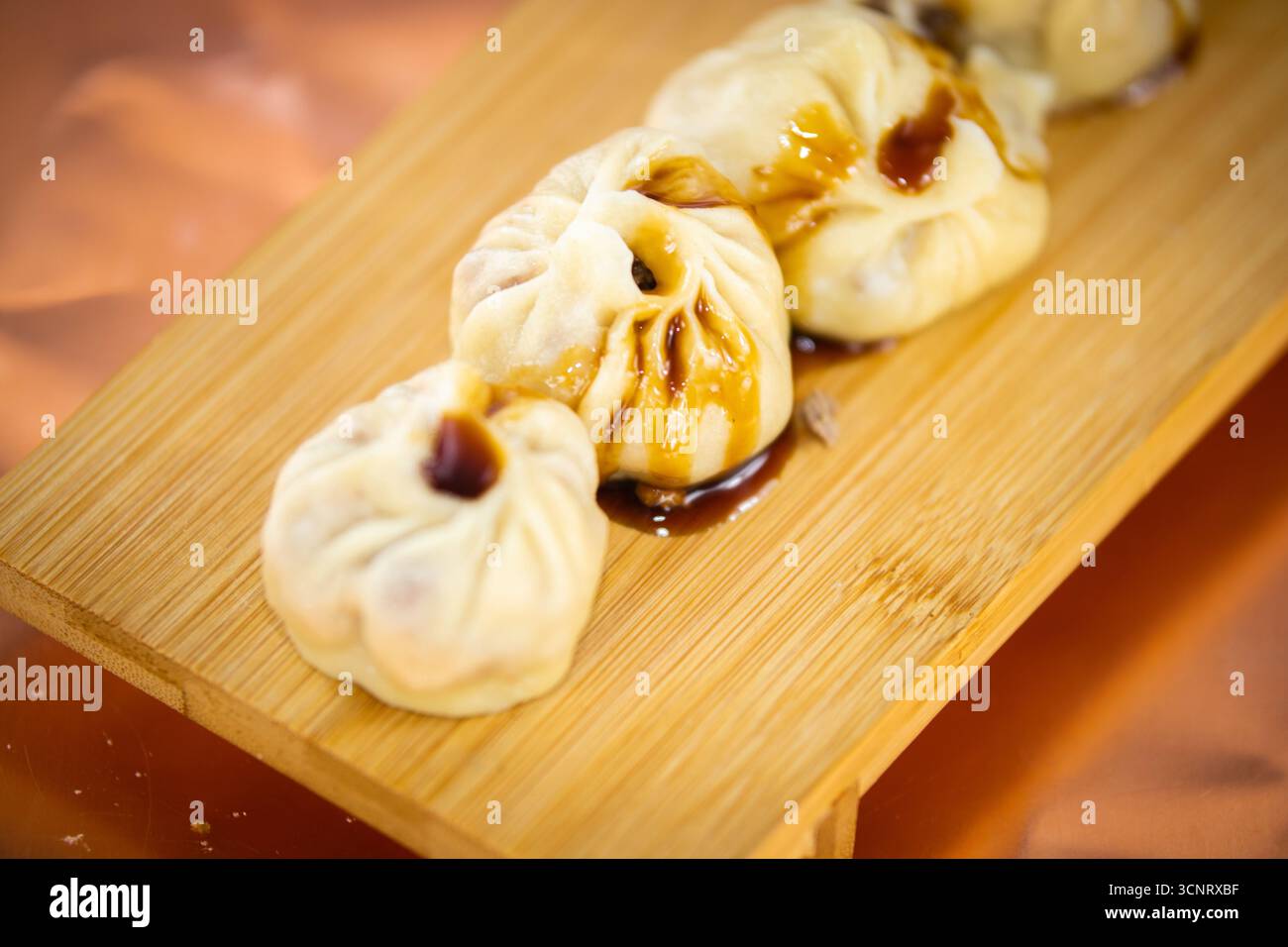 Raw and cooked Japanese gyoza dumplings on rustic surfaces – handmade ...