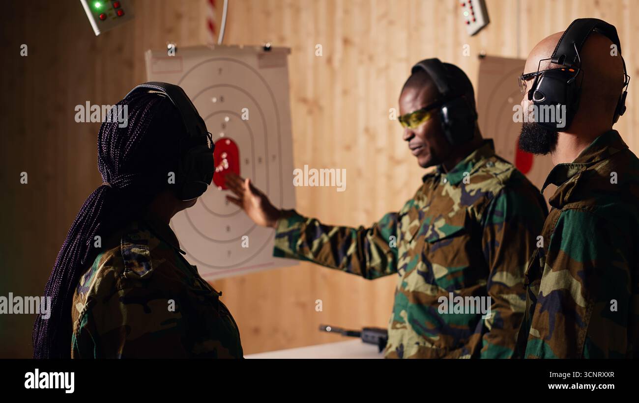 Portrait of joyous army soldiers wearing safety gear in shooting ...