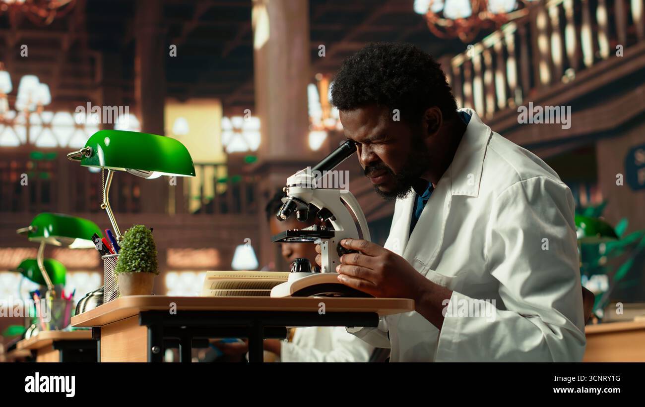 African American pupil studies microbiology in a campus library ...