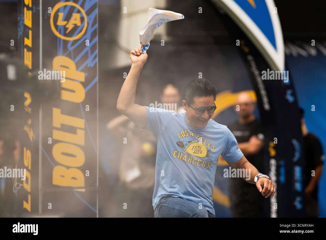 Actor Mario Lopez waves a towel before an NFL football game between the ...
