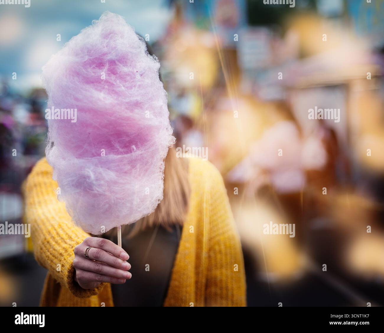 Colorful cotton candy at funfair held in hand, playful street food ...